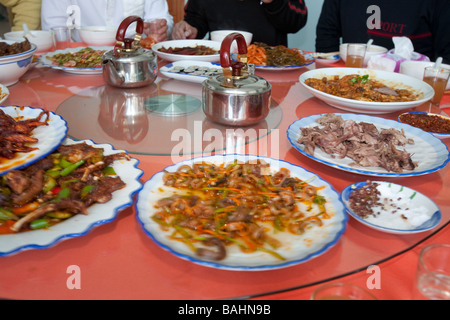 Chinese people sit down for a meal in a restaurant which includes ...