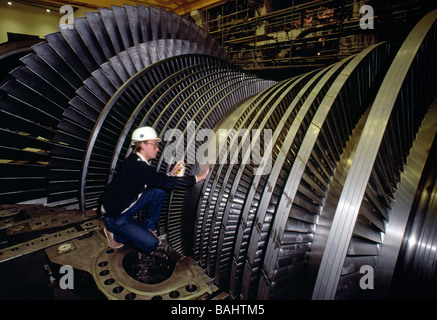 Male engineer inspecting the turbine rotors at a nuclear power plant ...