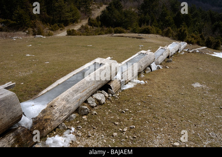 Troughs, watering place for livestock in mountains with frozen water ...