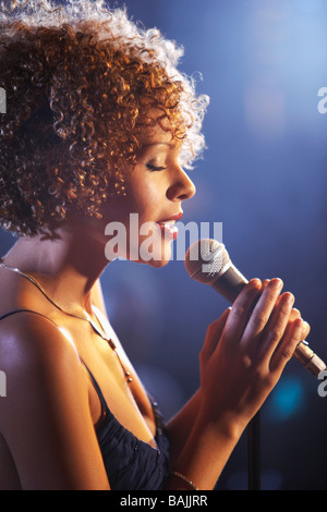 Jazz singer on stage, side view Stock Photo - Alamy