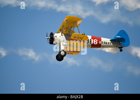 A US Navy version of the Stearman biplane trainer - in flight and seen ...