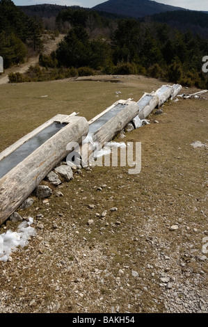 Troughs, watering place for livestock in mountains with frozen water ...