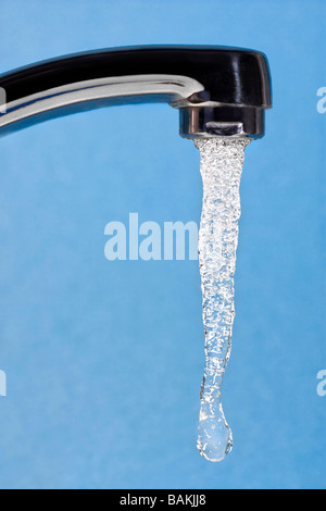 The water was gushing out from a metal pipe on the lawn Stock Photo - Alamy
