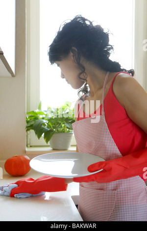 Young Women Wiping Bench Clean In Kitchen Stock Photo - Alamy