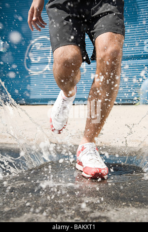 Stepping into a puddle Stock Photo - Alamy