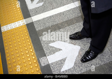 Shot Of Businessman's Feet Waiting On A Subway Platform Stock Photo - Alamy