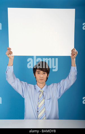 A blank piece of white paper sits on a brown background with dots. It ...