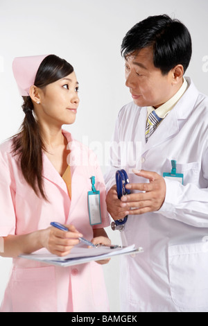 Asian women doctor holding clipboard medical record smiling ...