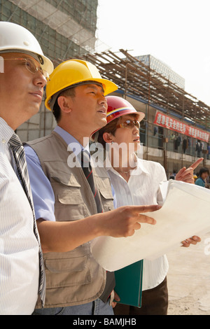Three business people are making plans and giving ideas Stock Photo - Alamy