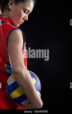 Front view female volleyball player beach holding ball with copy space ...