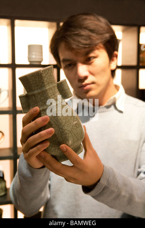 Man in a shop looking to the dishware Stock Photo - Alamy