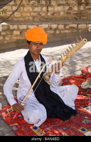 Young man playing a ravan hatta musical instrument, at Mehrangarh Fort ...