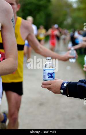 Drinks station at a running marathon, hydration drinking during a race ...