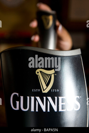 The Guinness Harp is seen on the pump as a pint is served to a customer ...
