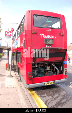Broken down bus in high street with rear mounted engine cover raised to ...