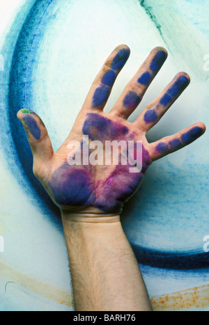 Messy art concept. Artists hands with stationery and colored paper ...