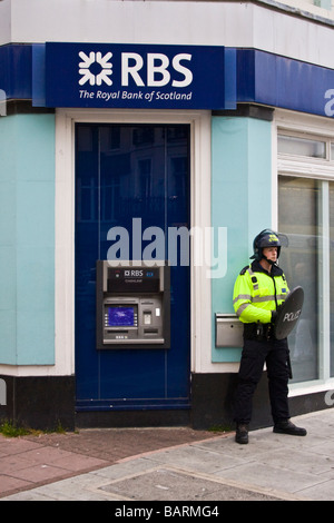 A police officer in riot gear stands guard outside of Seattle Central ...