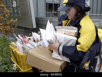An employee of the Deutsche Post (German mail) works at the letter ...