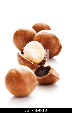 Macadamia nuts in the shell and without it in plastic containers in the ...