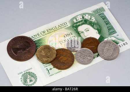 British pre decimal coins and 1 Pound banknote, UK, on white background ...