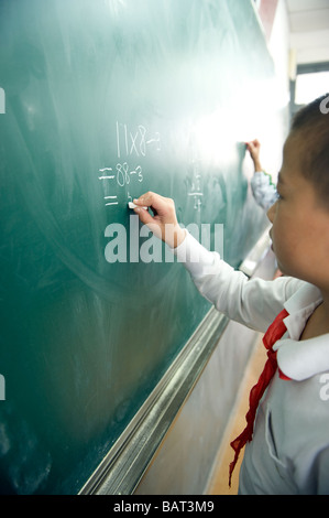 Young student practicing math on a chalkboard Stock Photo - Alamy
