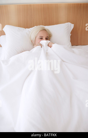 Woman hiding face behind with pillow on grey background. National Sleep ...