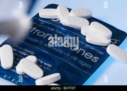 White caplet on blue caplets background Stock Photo - Alamy