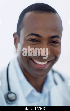 Portrait of male doctor in face mask and gloves working on laptop ...