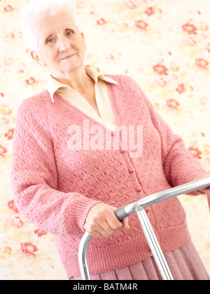 Elderly woman holding a zimmer frame for walking assistance. Senior ...