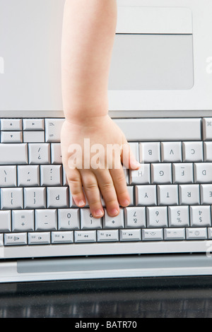 Baby typing on a computer keyboard in a white isolated background Stock ...