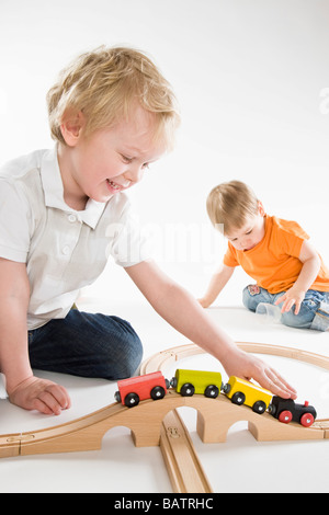 Kids play with wooden railway. Child with toy train. Educational toys ...