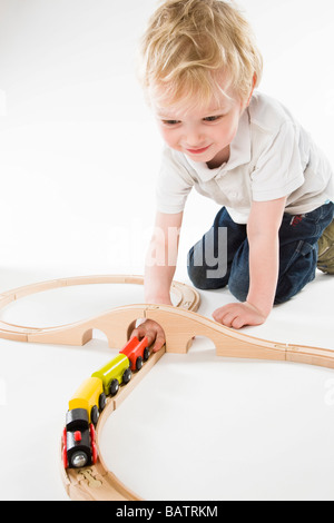 Kids play with wooden railway. Child with toy train. Educational toys ...