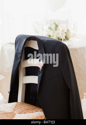 A vertical shot of a groom's boutonniere on a suit Stock Photo - Alamy