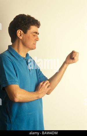 Man scratching his arm Stock Photo - Alamy
