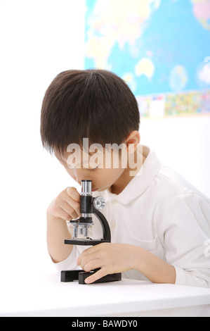 Asian boy looking through microscope at science fair - USA Stock Photo ...