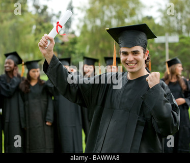 Man in graduation hat and with diploma on white background Stock Photo ...