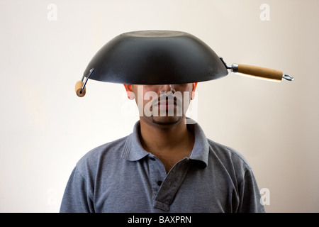Man with Wok on head isolated on white Stock Photo - Alamy