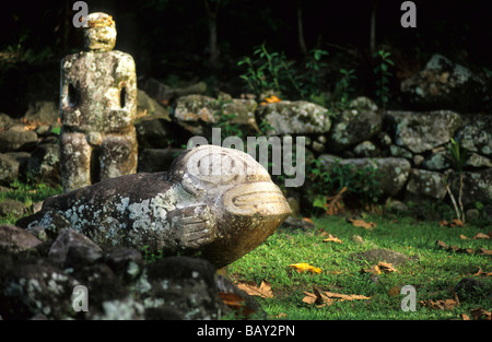 Weather beaten stone statues at an archaeological site in the village ...