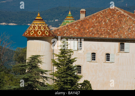 The castle of Aiguines with its coloured roof tiles in front of the ...