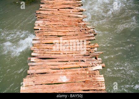 A bridge made of wooden planks across a ditch Stock Photo - Alamy