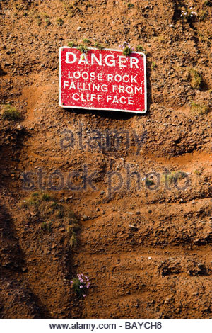 Danger loose rocks falling rock area sign on verge in Newlyn Cornwall ...