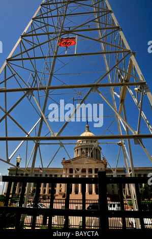 An oil derrick stands in front of the Oklahoma capitol building ...