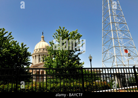 An oil derrick stands in front of the Oklahoma capitol building ...