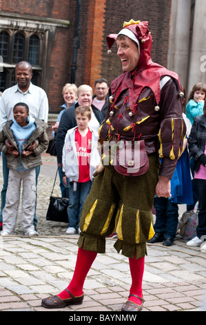 A court jester performs fire eating tricks at Hampton Court Palace ...