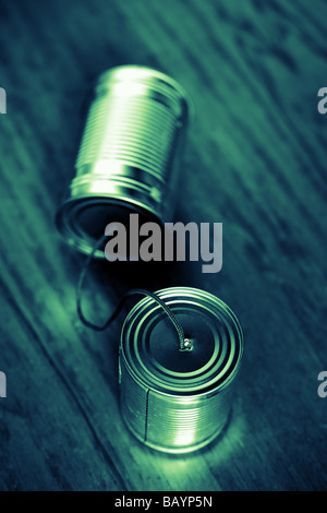 Two tin cans linked with string Stock Photo - Alamy
