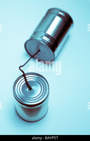 Two tin cans linked with string Stock Photo - Alamy
