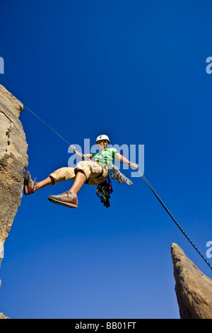 A rock climber rappelling from a rock spire Stock Photo - Alamy