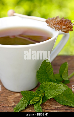 Mint leaves, brown sugar and cup of mint tea Stock Photo - Alamy