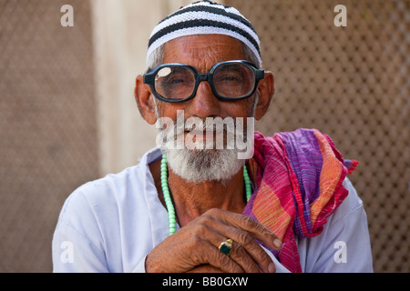 Elderly big Indian Muslim man with henna-dyed Muslim beard wears a ...