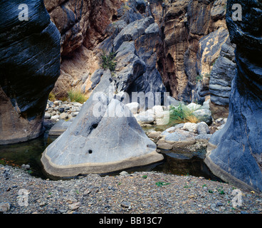 Pebbles in Wadi "Bani Awf" with typical view of Al Jabal al Akhdar ...